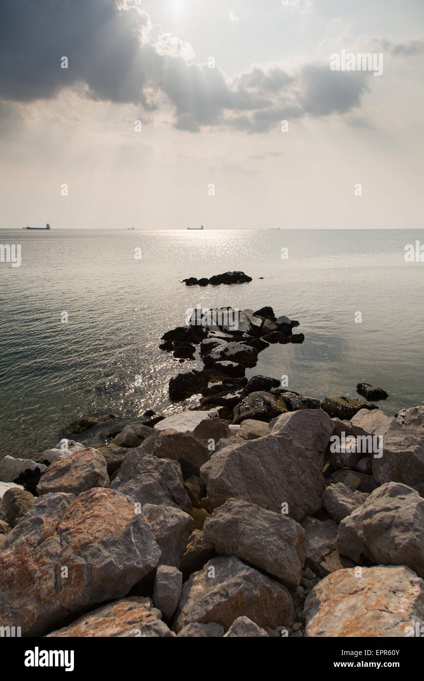 Scattered clouds produce beautiful rays of sunlight over the ships ...