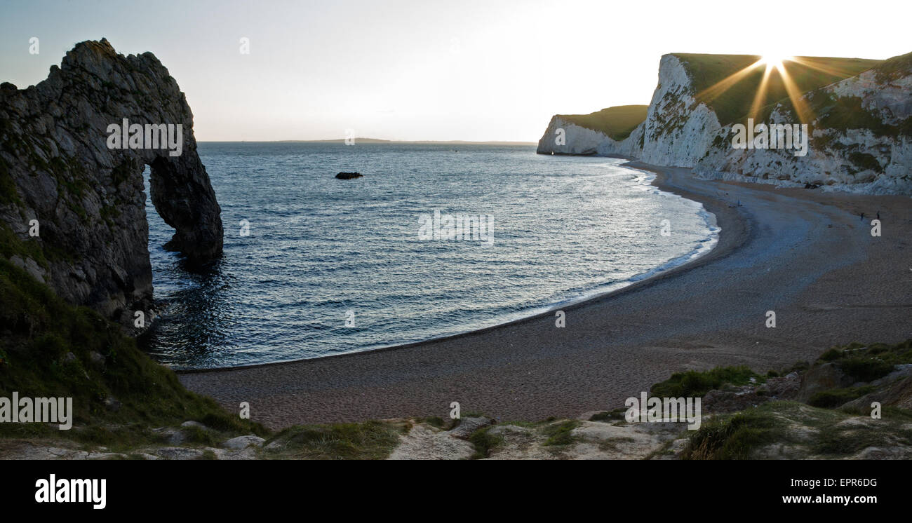 Durdle Door beach as the sun disappears over the cliffs, Dorset ...