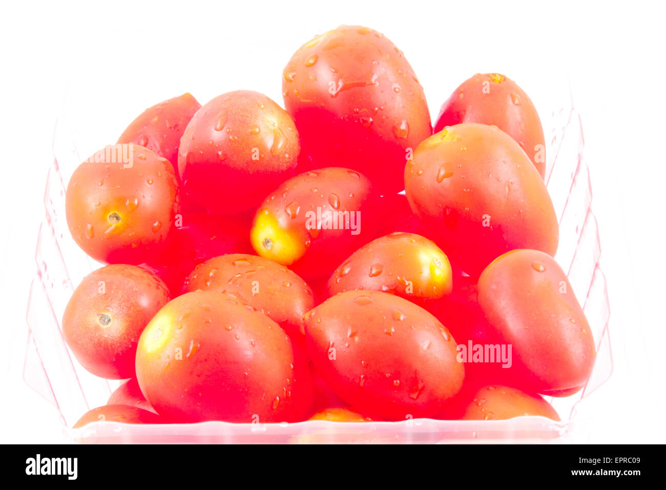 Bunch of grape tomatoes in plastic container isolated on white Stock ...