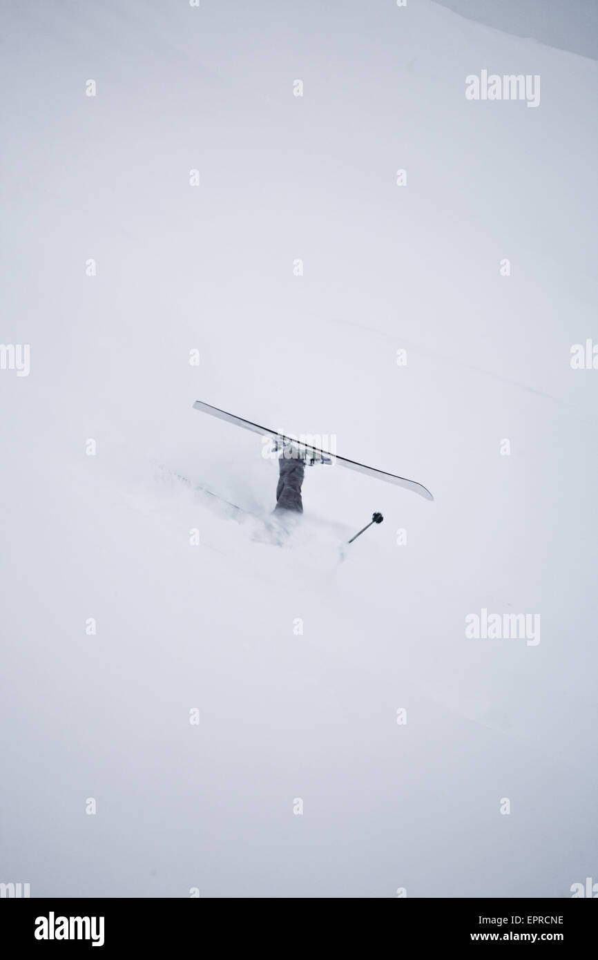 Skier stuck upside-down after falling in the powder snow Stock Photo ...