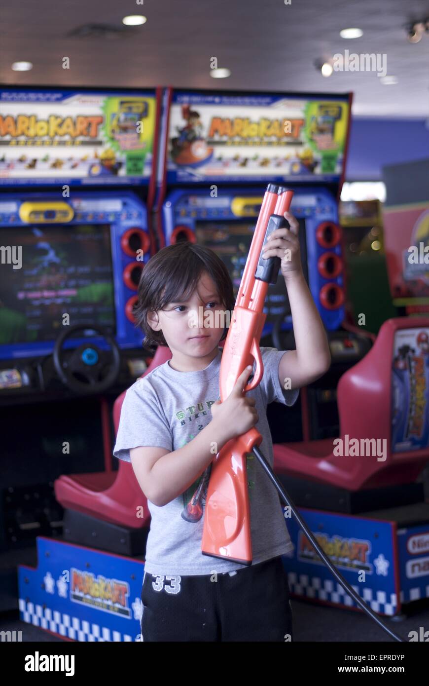 Little boy at arcade Stock Photo - Alamy