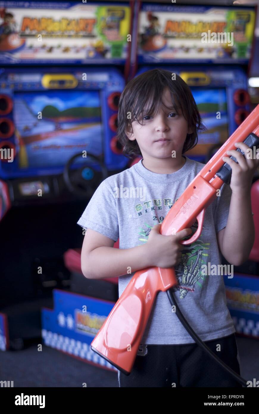 Little boy at arcade Stock Photo - Alamy