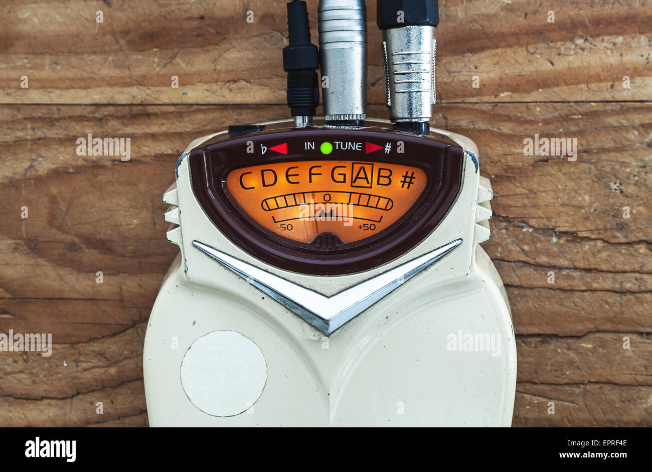 Details of an old guitar tuner, solid built with dust on surface ...
