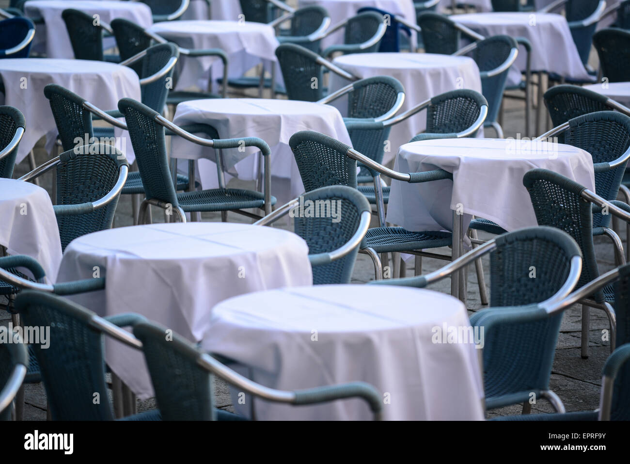 Street view of a coffee terrace with tables and chairs Stock Photo - Alamy