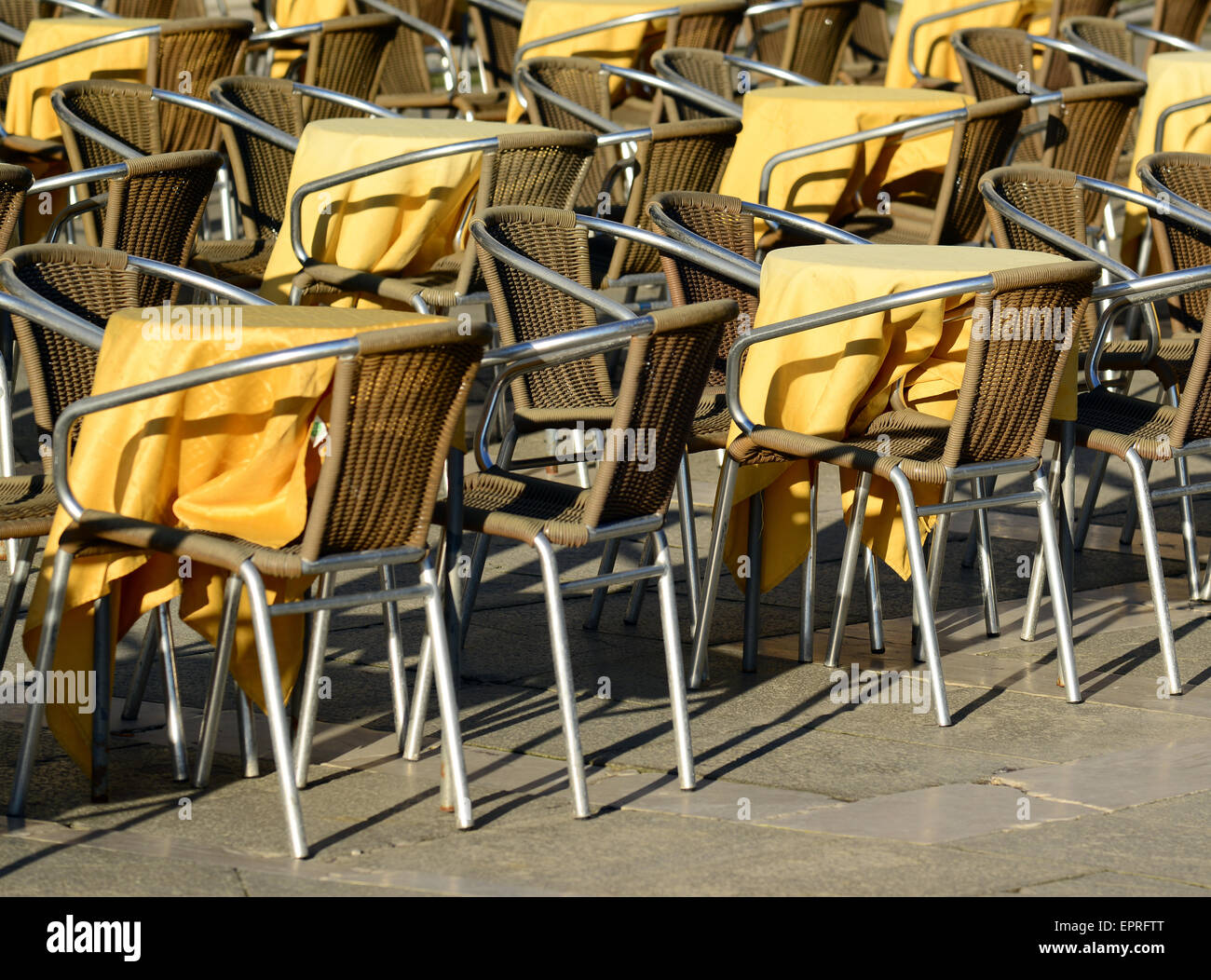 Street view of a coffee terrace with tables and chairs Stock Photo - Alamy