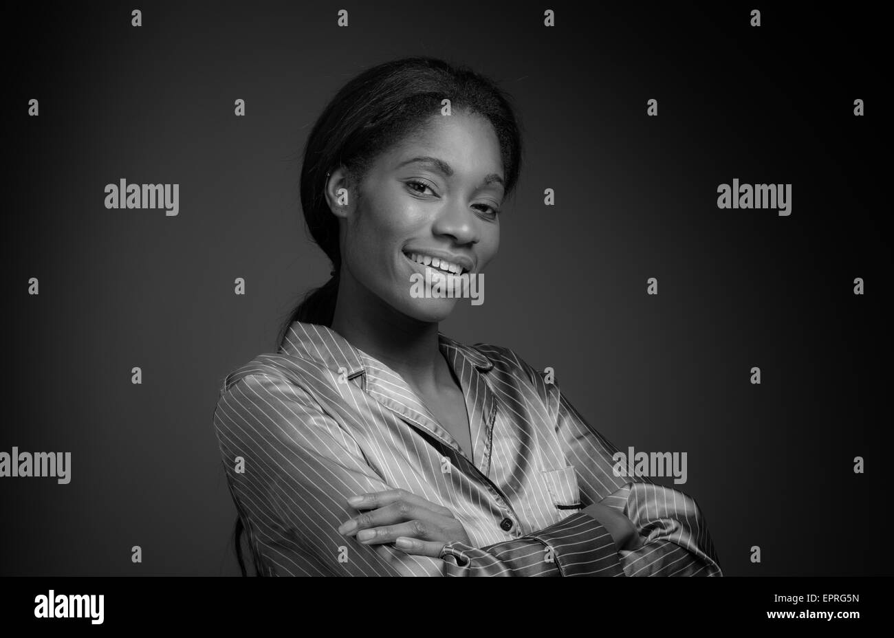 Model successful with arms crossed confident Stock Photo - Alamy