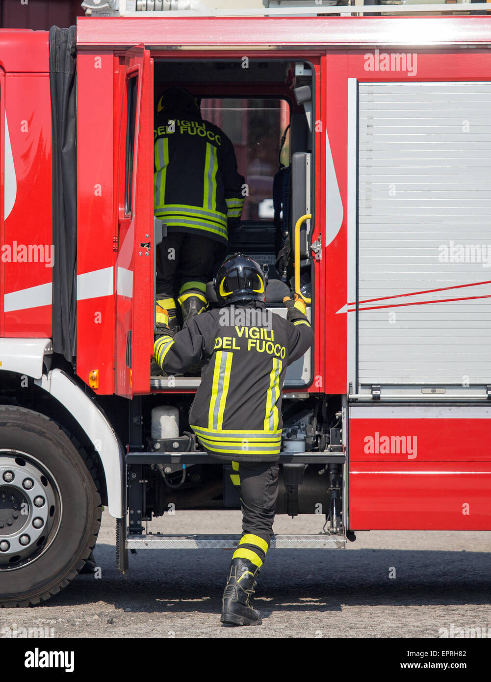 Italian firefighters climb on the trucks of firefighters during an ...