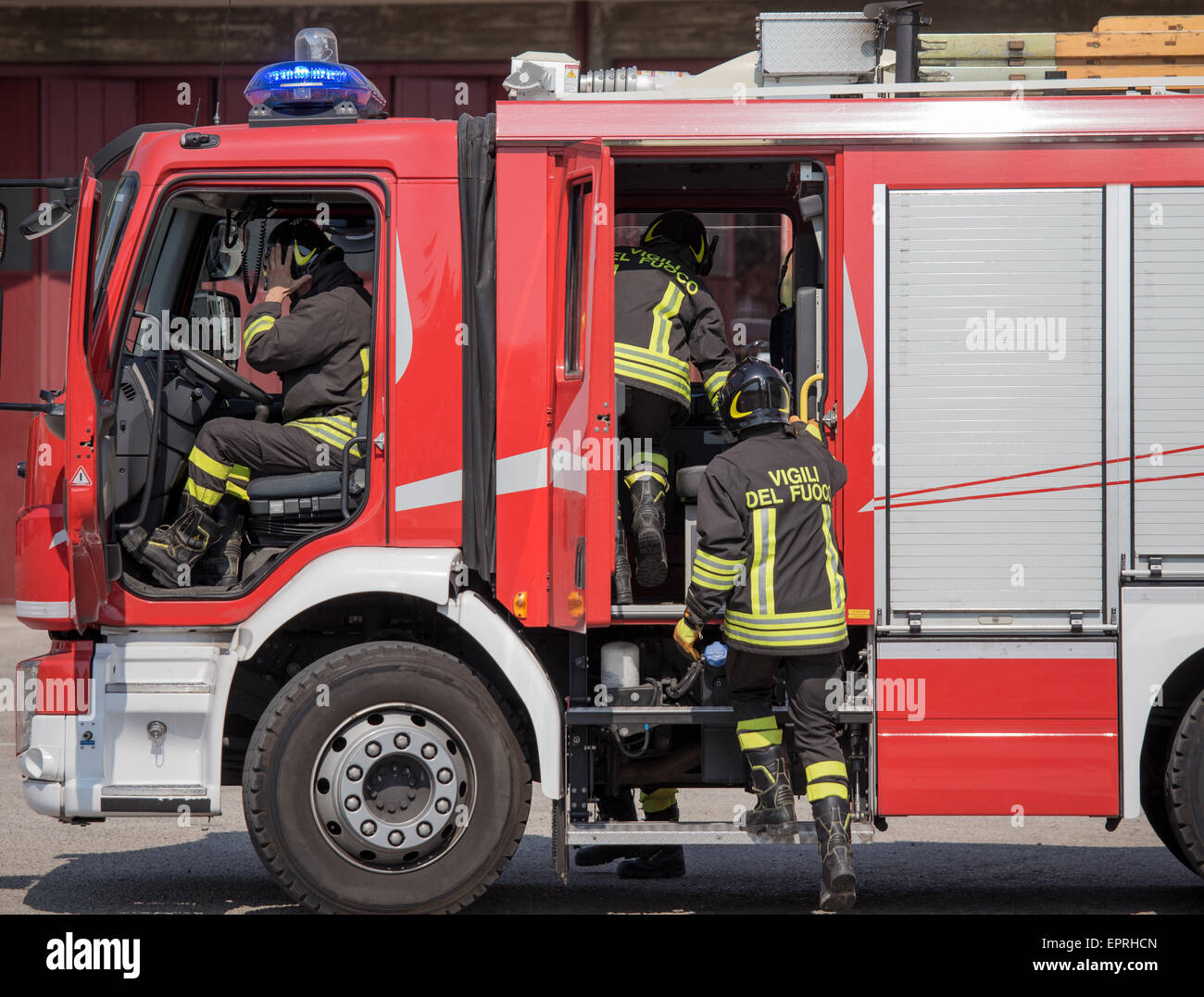 fast Italian firefighters climb on firetrucks during an emergency Stock ...