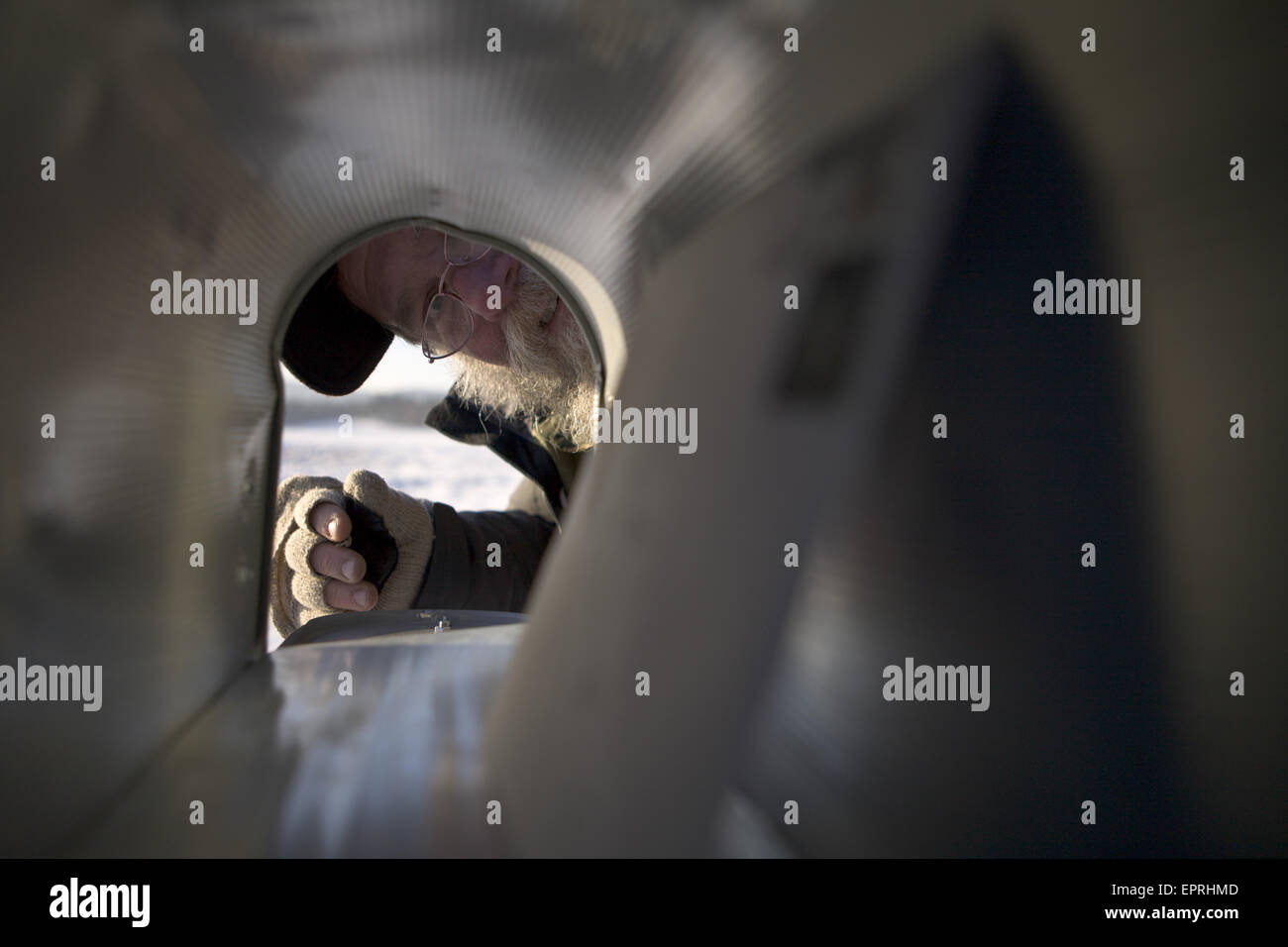 Bearded man looks inside mailbox for single letter Stock Photo - Alamy