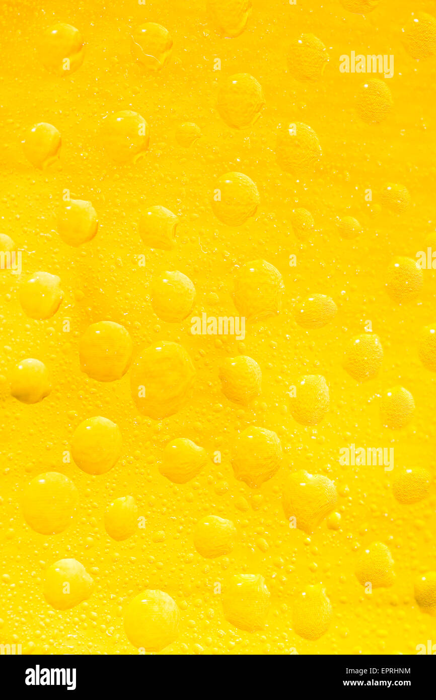 Group of drops portrait on yellow background Stock Photo - Alamy