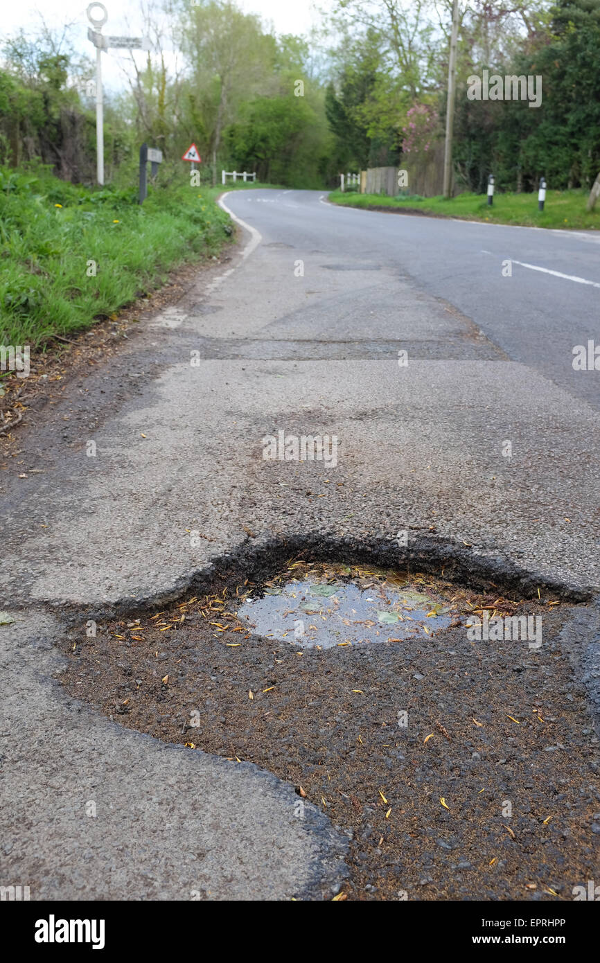 A road with a pothole Stock Photo - Alamy