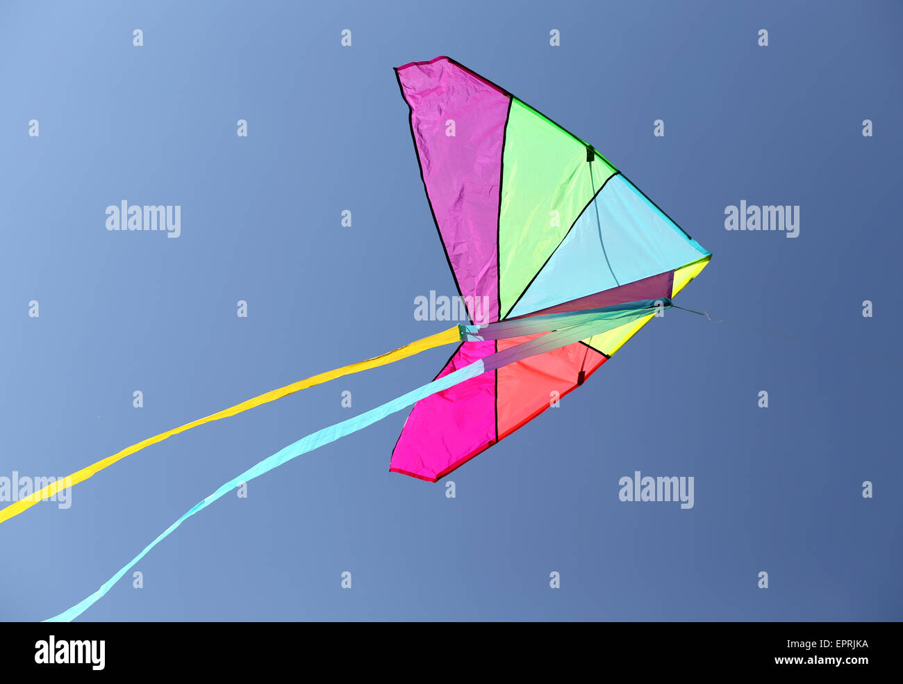 huge colorful kite flying high in the sky blue Stock Photo - Alamy