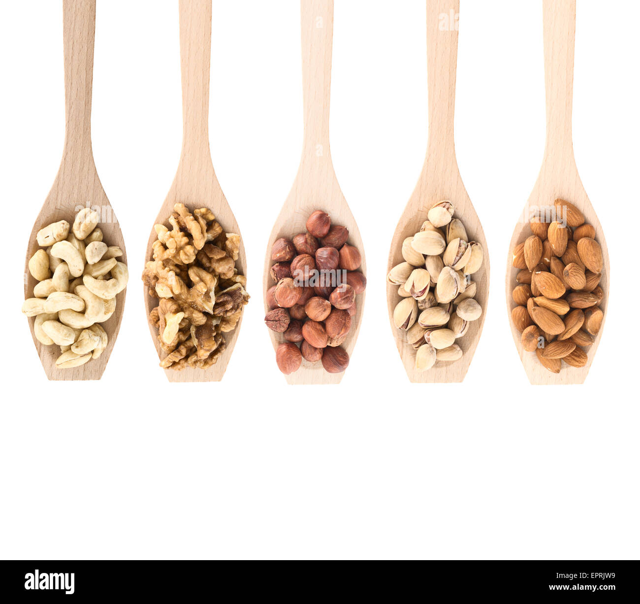 Wooden spoons full of different nuts Stock Photo - Alamy