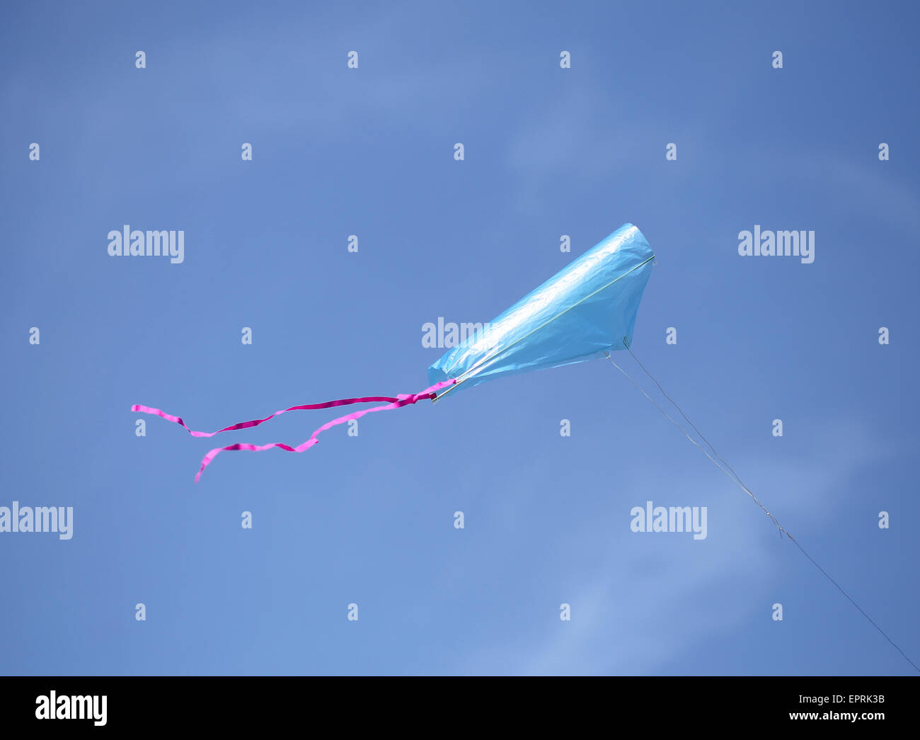 Azure kite with tails magenta flies high in the sky Stock Photo - Alamy