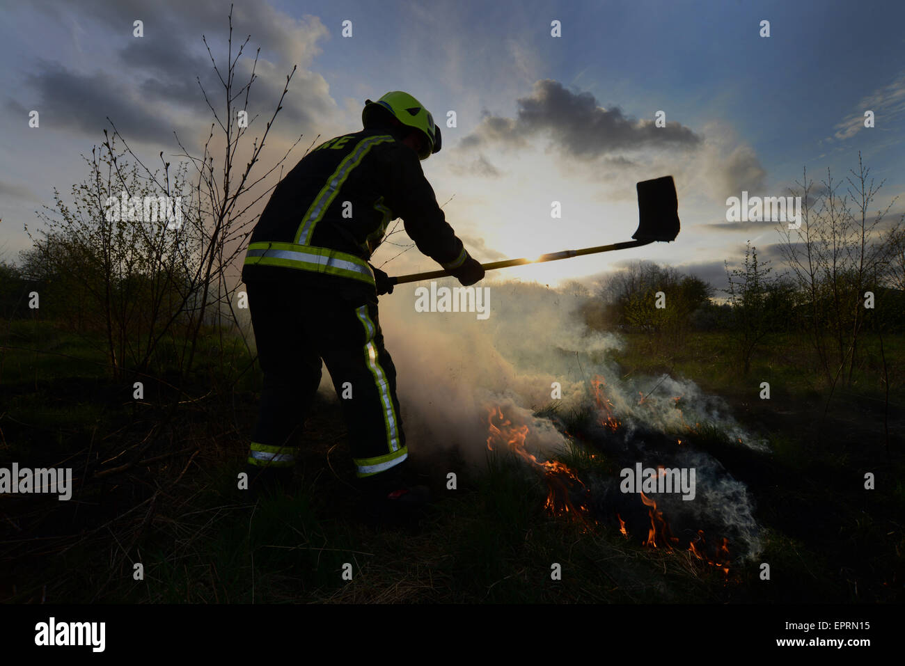A firefighter putting out flames at a field fire. Picture: Scott ...