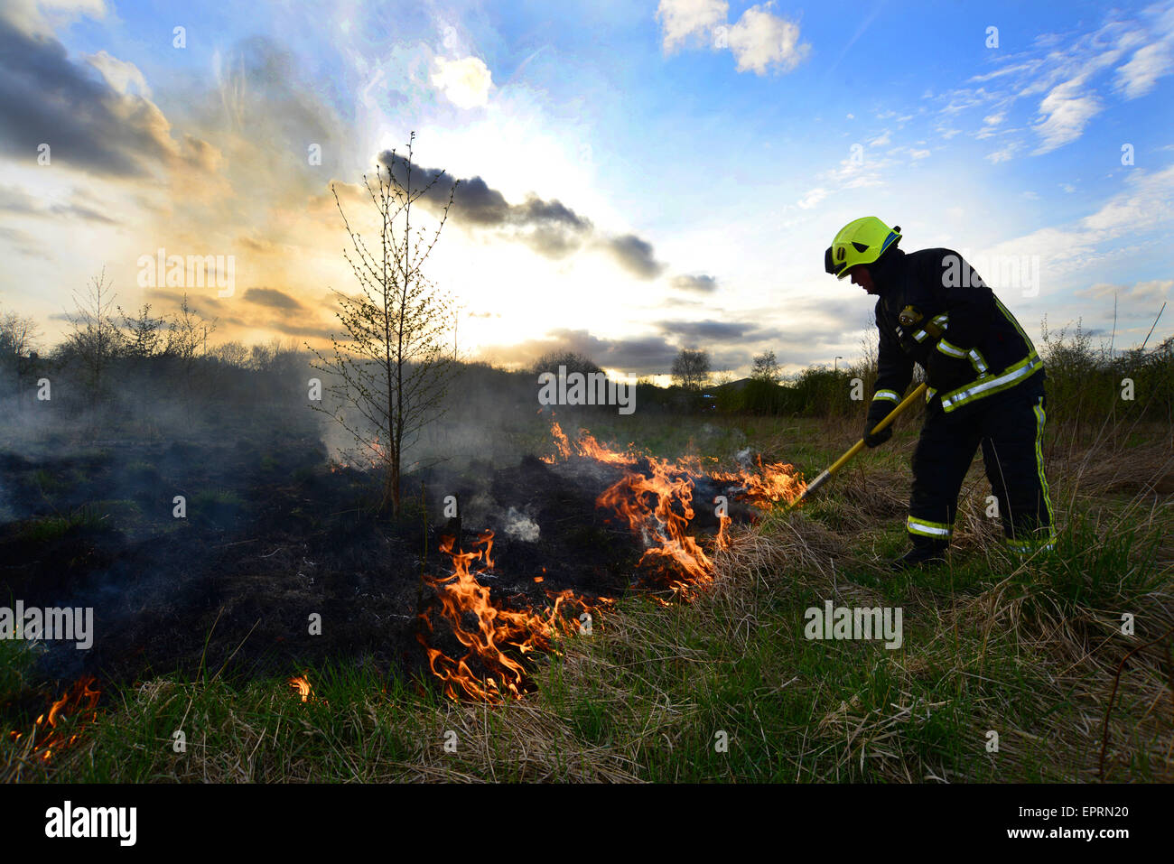 A firefighter putting out flames at a field fire. Picture: Scott ...
