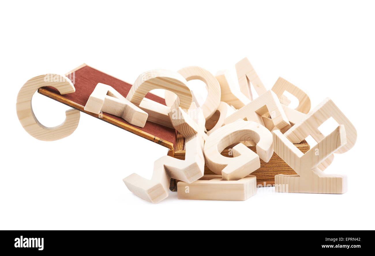 Multiple wooden letters in a book Stock Photo - Alamy