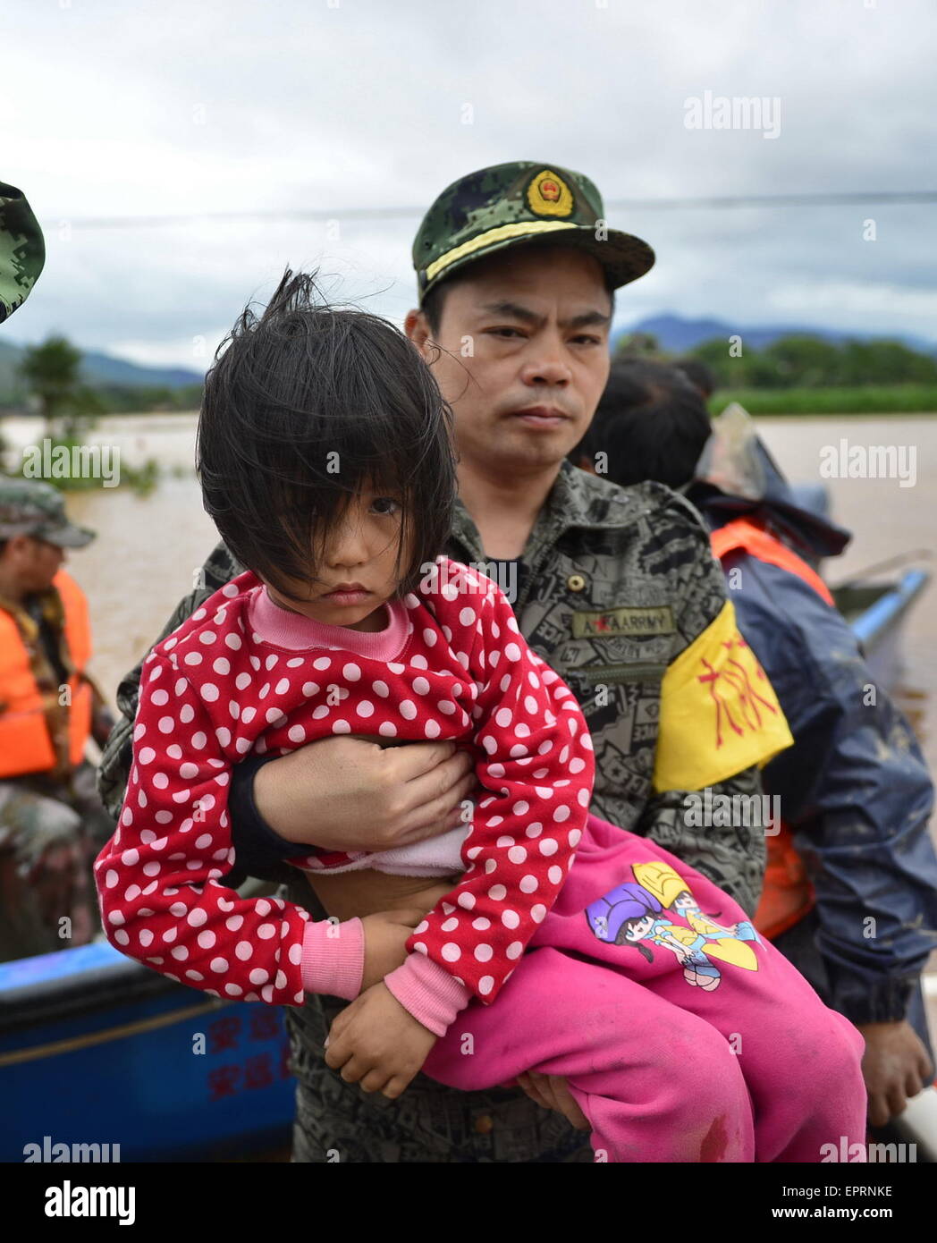 Nanchang. 21st May, 2015. A rescuer carries a girl to safer place in ...