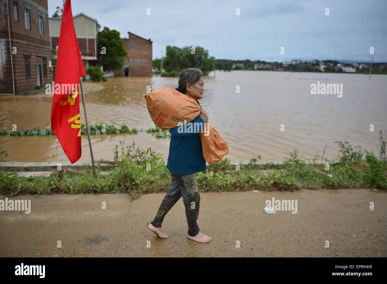 Nanchang. 21st May, 2015. A relocated villager walks in Chexi Town of ...