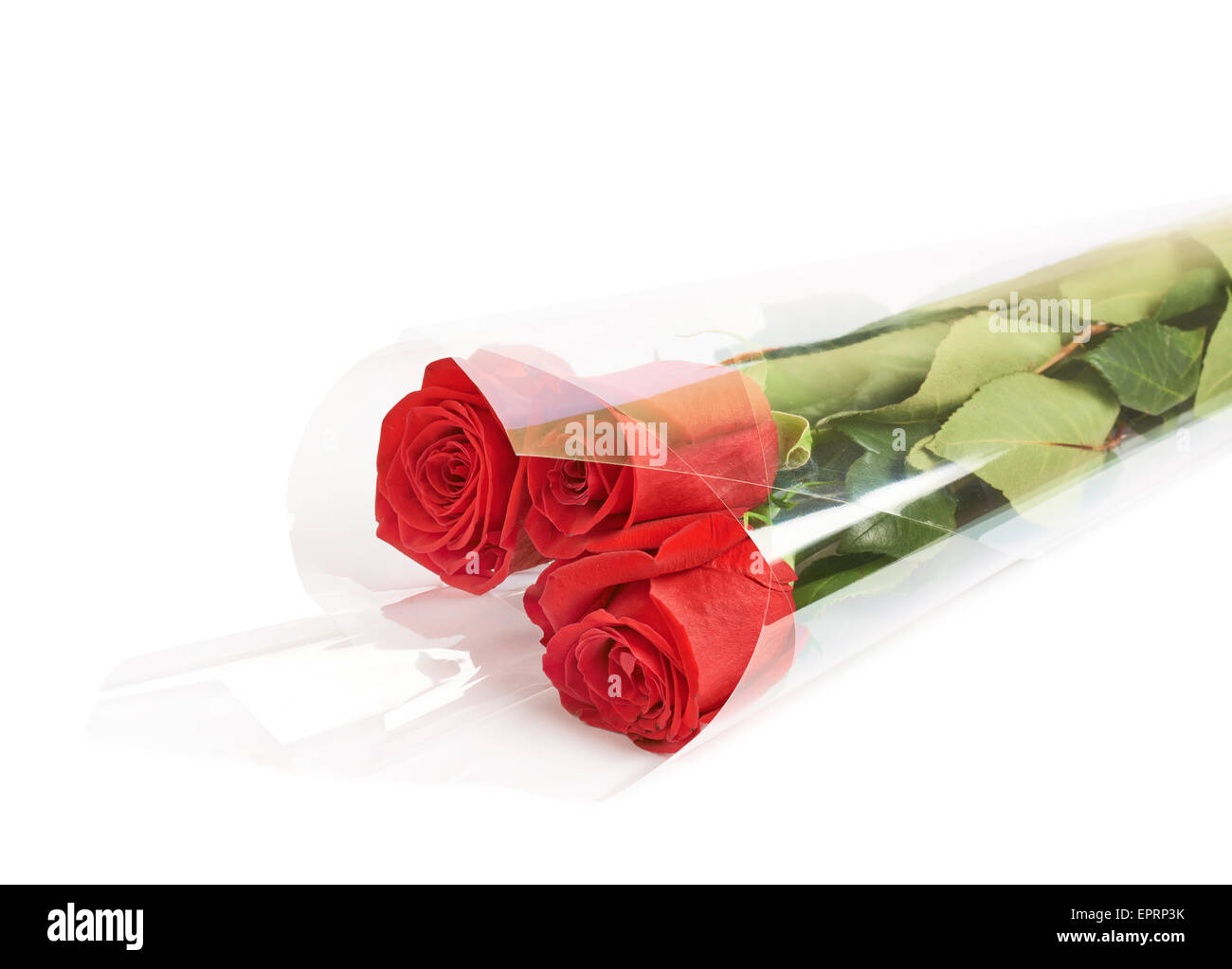 Three red roses in a wrapping Stock Photo - Alamy