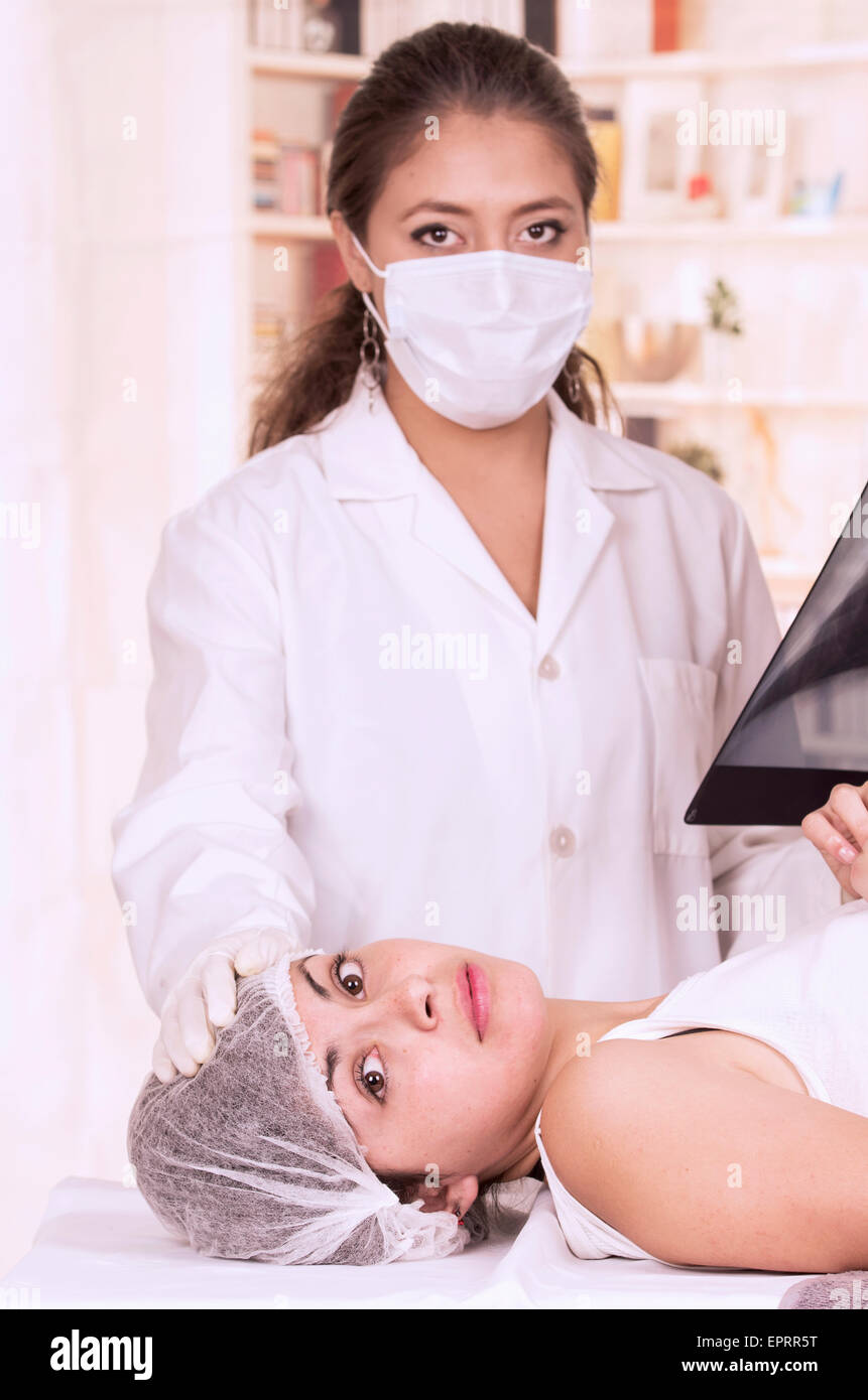 Female doctor checking xray of a young girl patient Stock Photo - Alamy