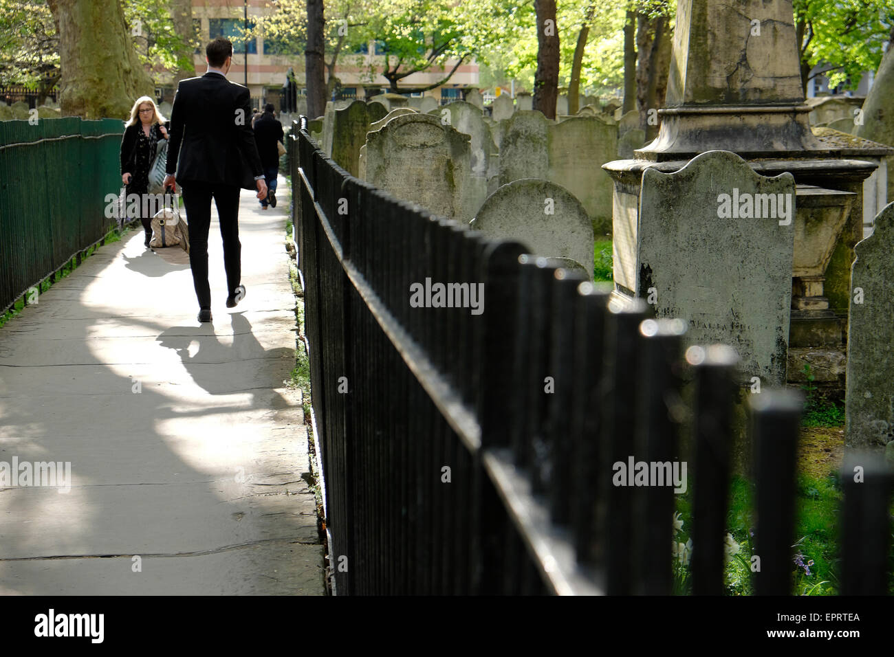 People walking along the graveyard path or walkway in Bunhill Fields ...