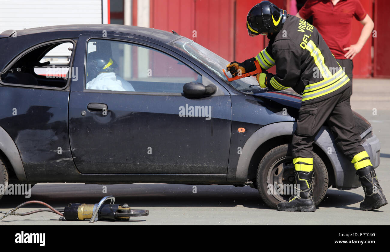 firefighters during exercise in fire station cut a car glass Stock ...