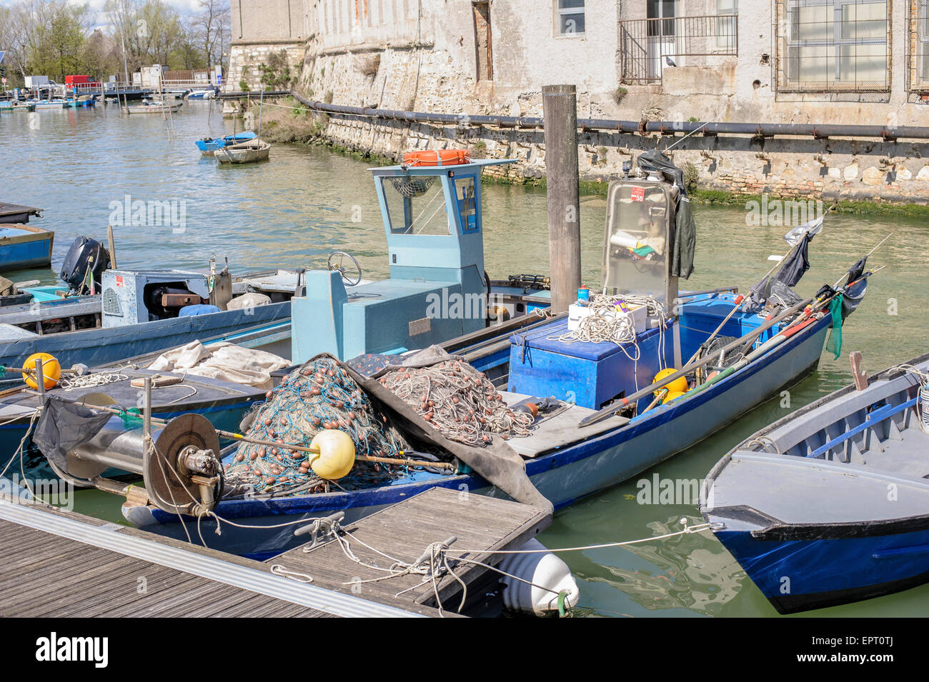 Fishing boat and fishing nets in the harbor Stock Photo - Alamy