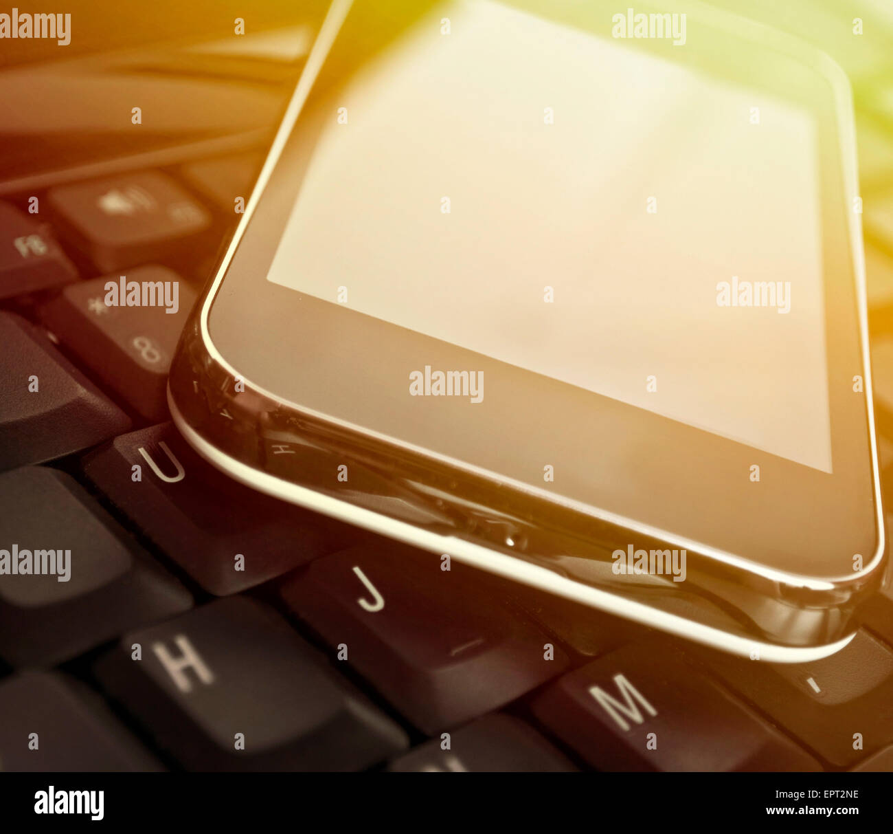 Cell phone on laptop keyboard - Business concept Stock Photo - Alamy