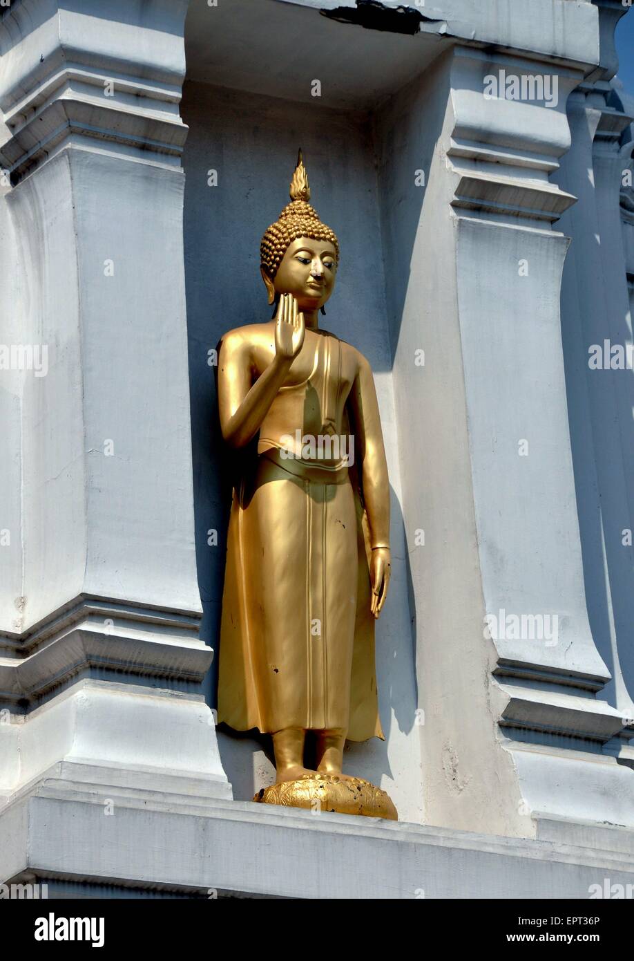 Bangkok, Thailand: Standing Buddha with upraised hand set in a niche of ...