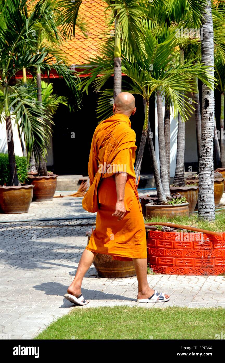 Bangkok, Thailand: Buddhist monk in orange robe walking in the gardens ...