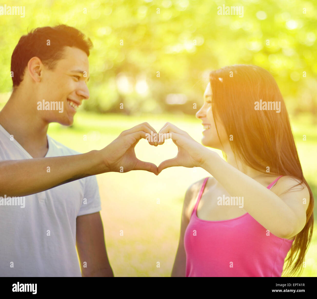 Couple making heart with hands outdoor Stock Photo - Alamy