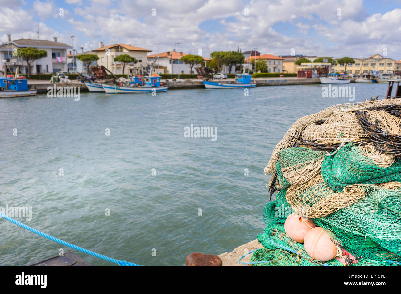 Fishing nets, fishing boats in the background Stock Photo - Alamy