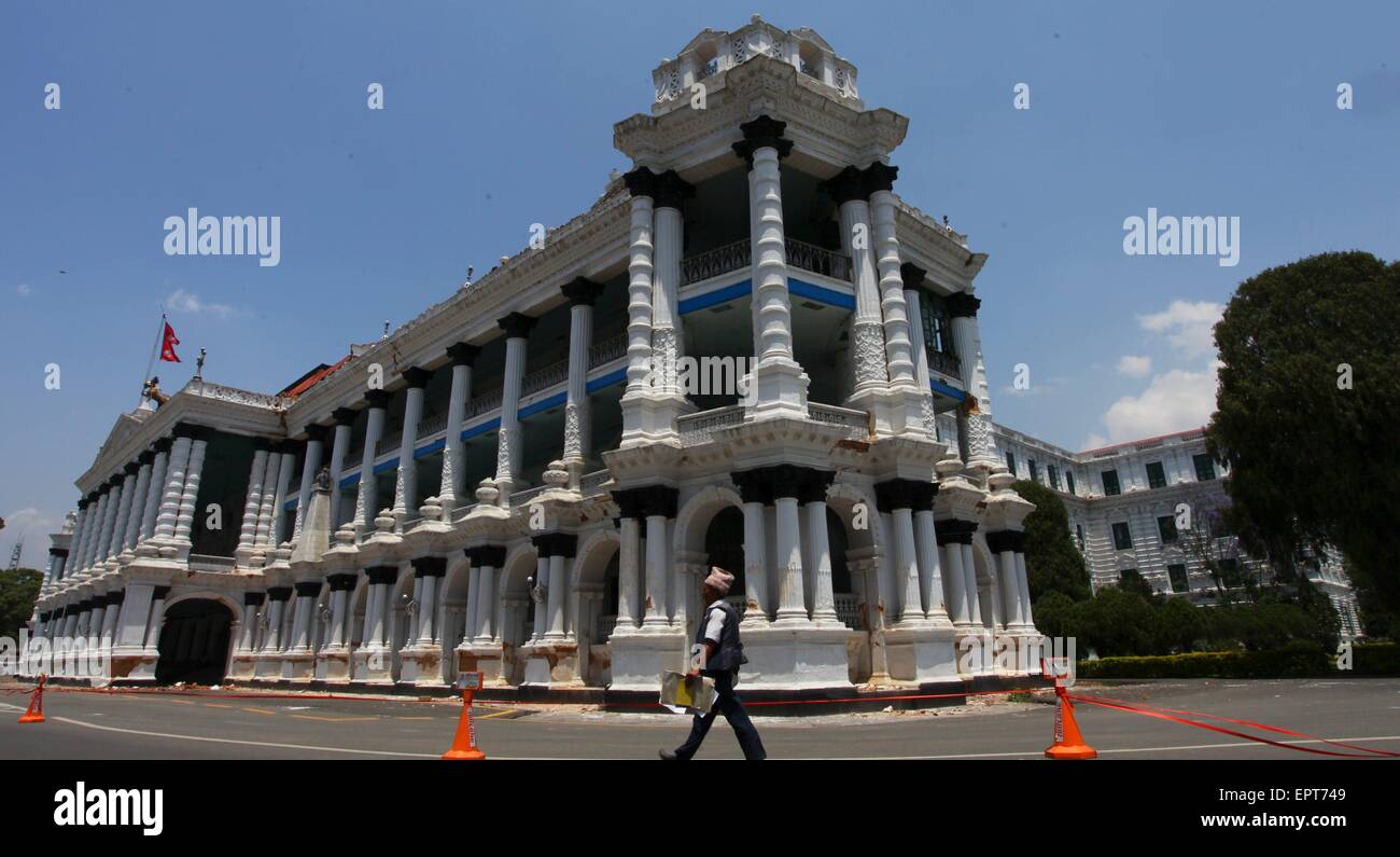 Kathmandu, Nepal. 21st May, 2015. An office staff passes by the damaged ...