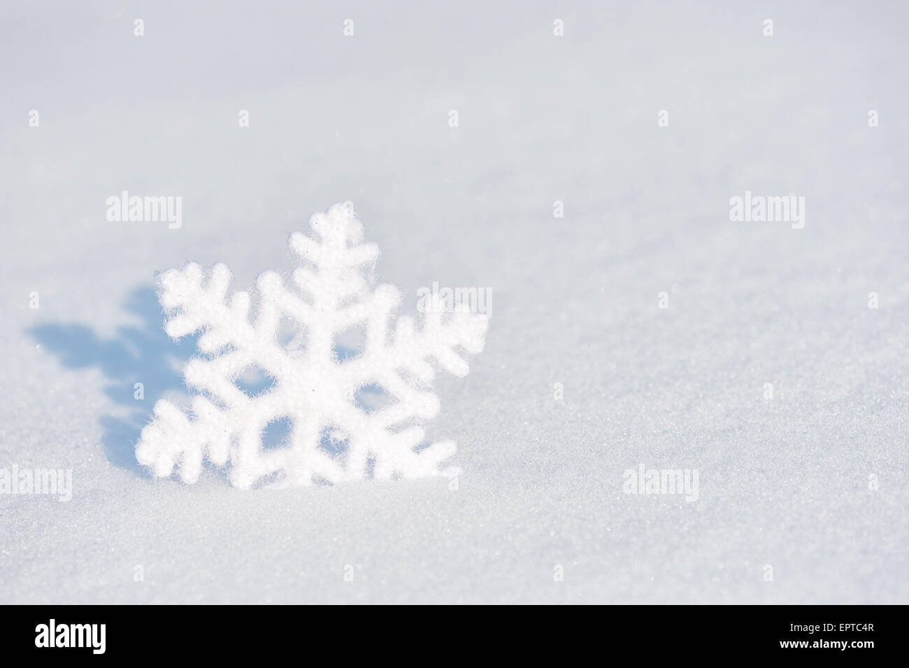 big snowflake in snow background Stock Photo - Alamy