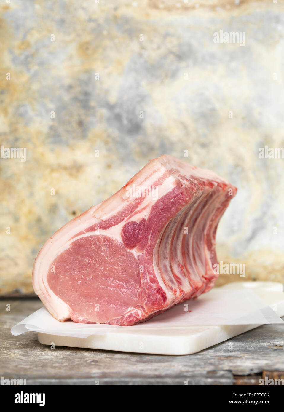 Rack of Raw Pork Chops on Parchment and Marble Slab, Studio Shot Stock ...