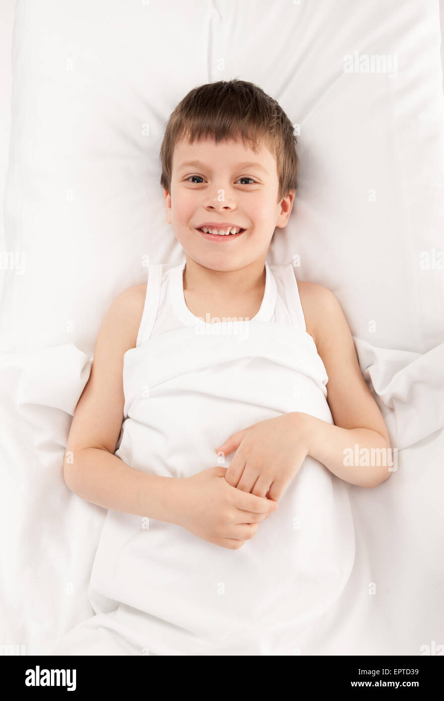 boy lying in bed on white Stock Photo - Alamy
