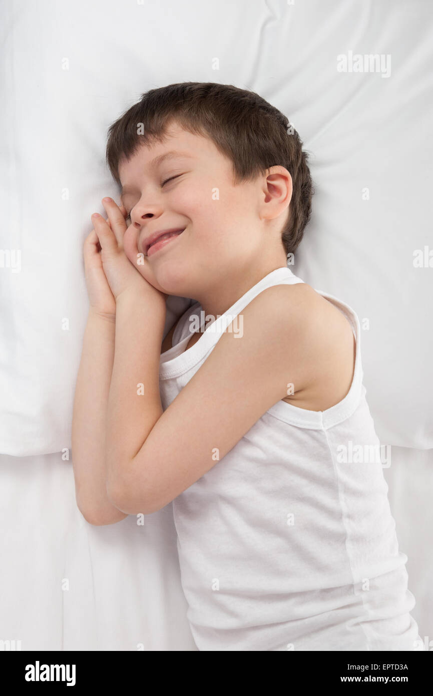 cheerful boy sleep in white bed Stock Photo - Alamy
