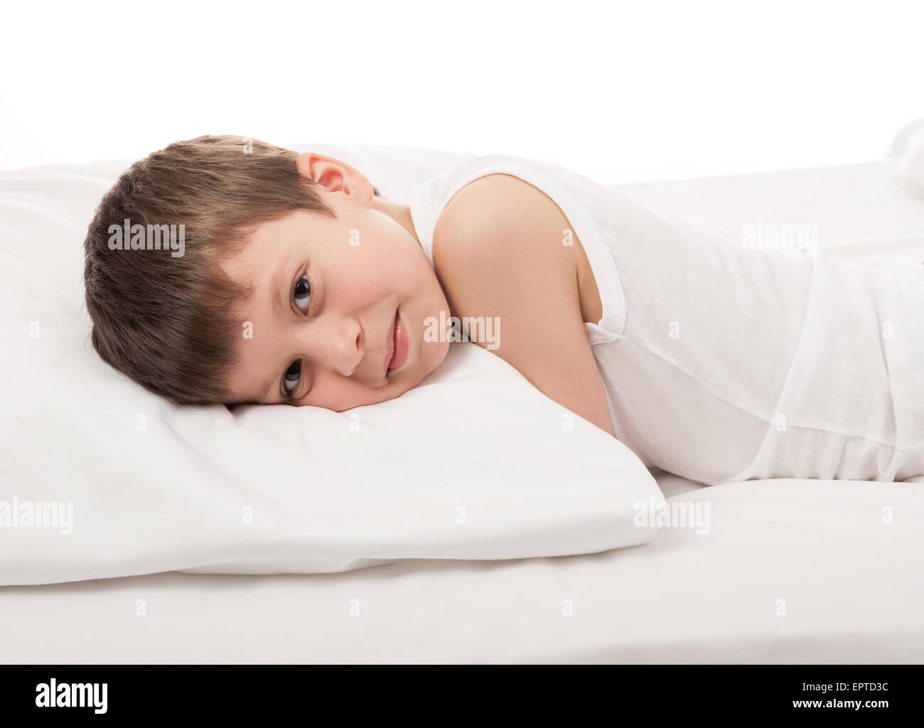boy lying in bed on white Stock Photo - Alamy