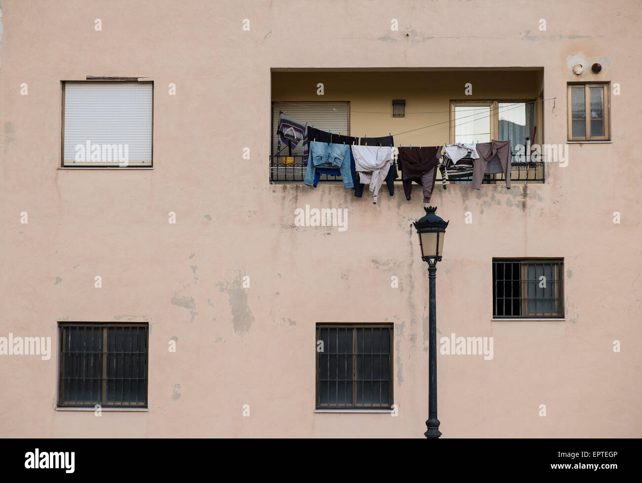 A run down facade with clothes hanging from a window Stock Photo - Alamy