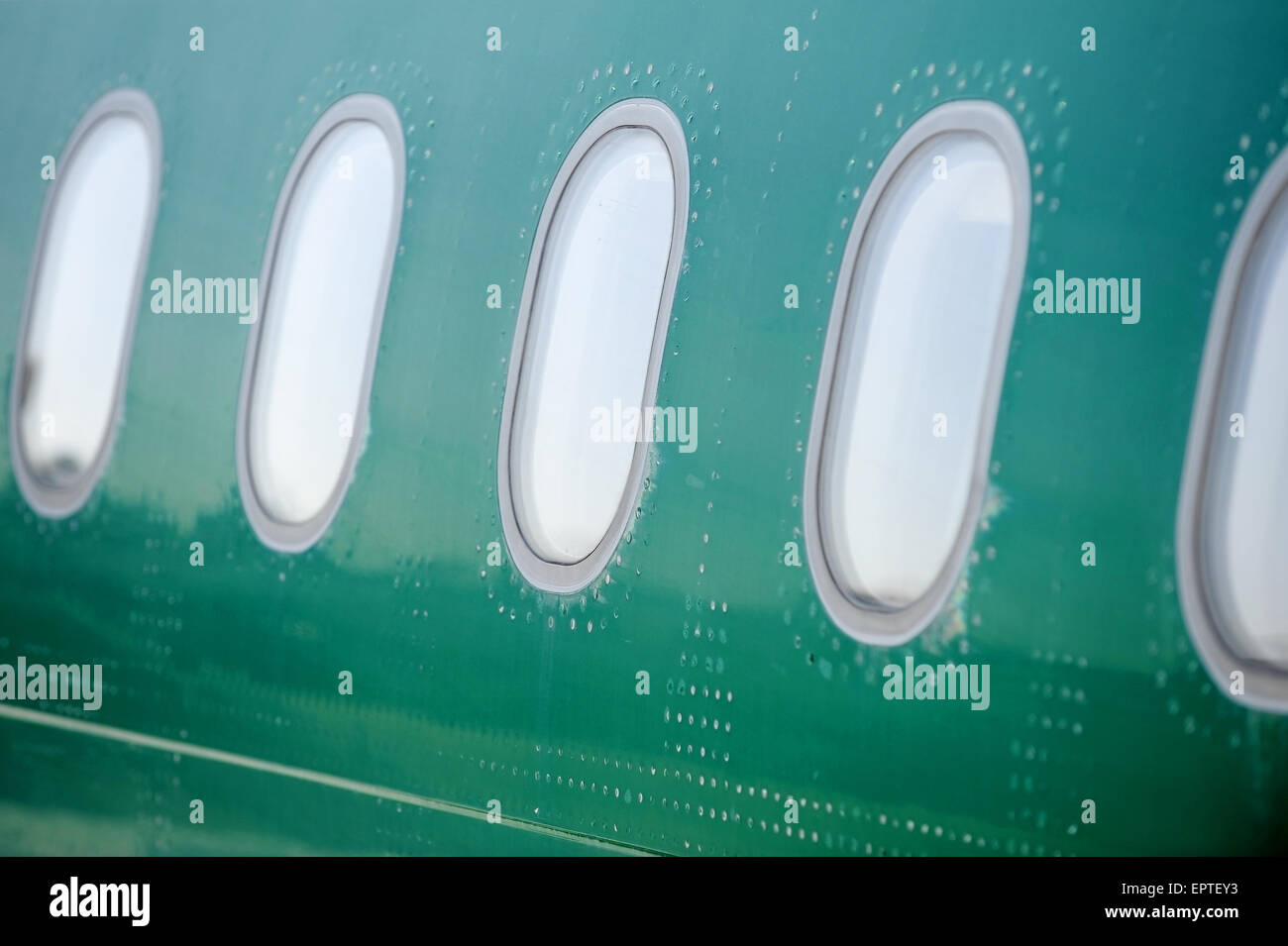 Airplane windows in a row on a green fuselage Stock Photo - Alamy