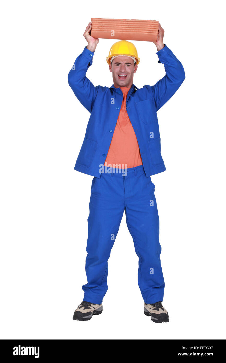 Man lifting large brick over head Stock Photo - Alamy