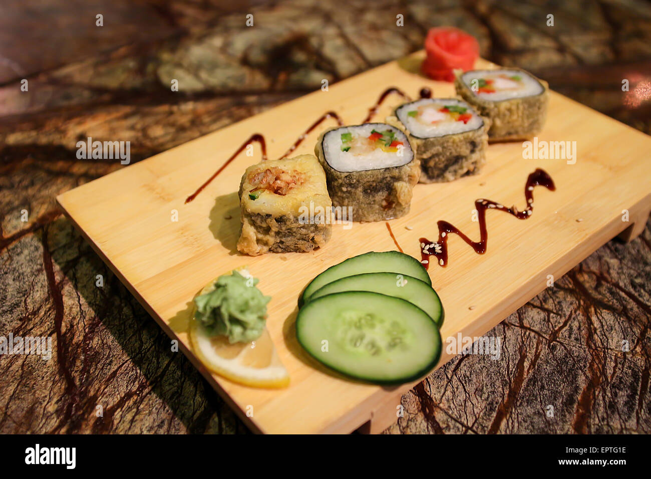 Delicious Magura grill maki sushi rolls served with a wood plate Stock ...