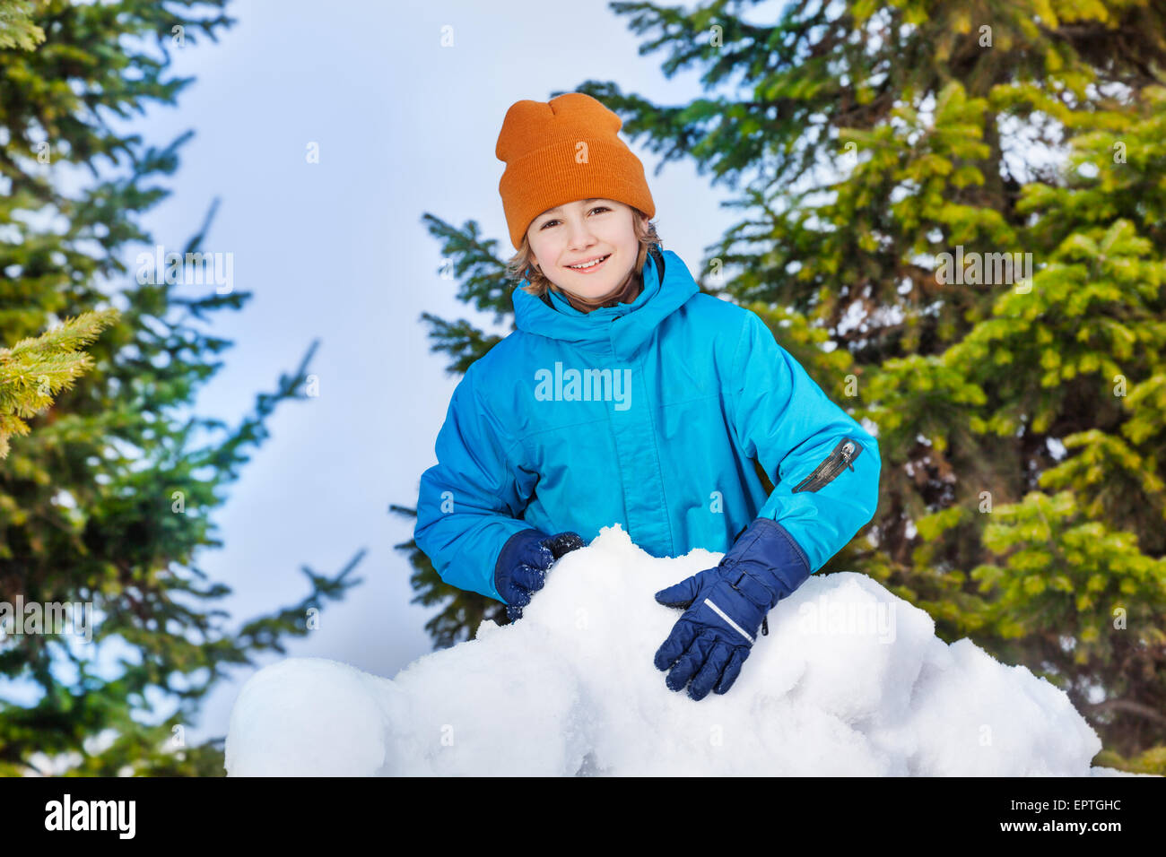 Cute child building snow fortress closeup Stock Photo - Alamy