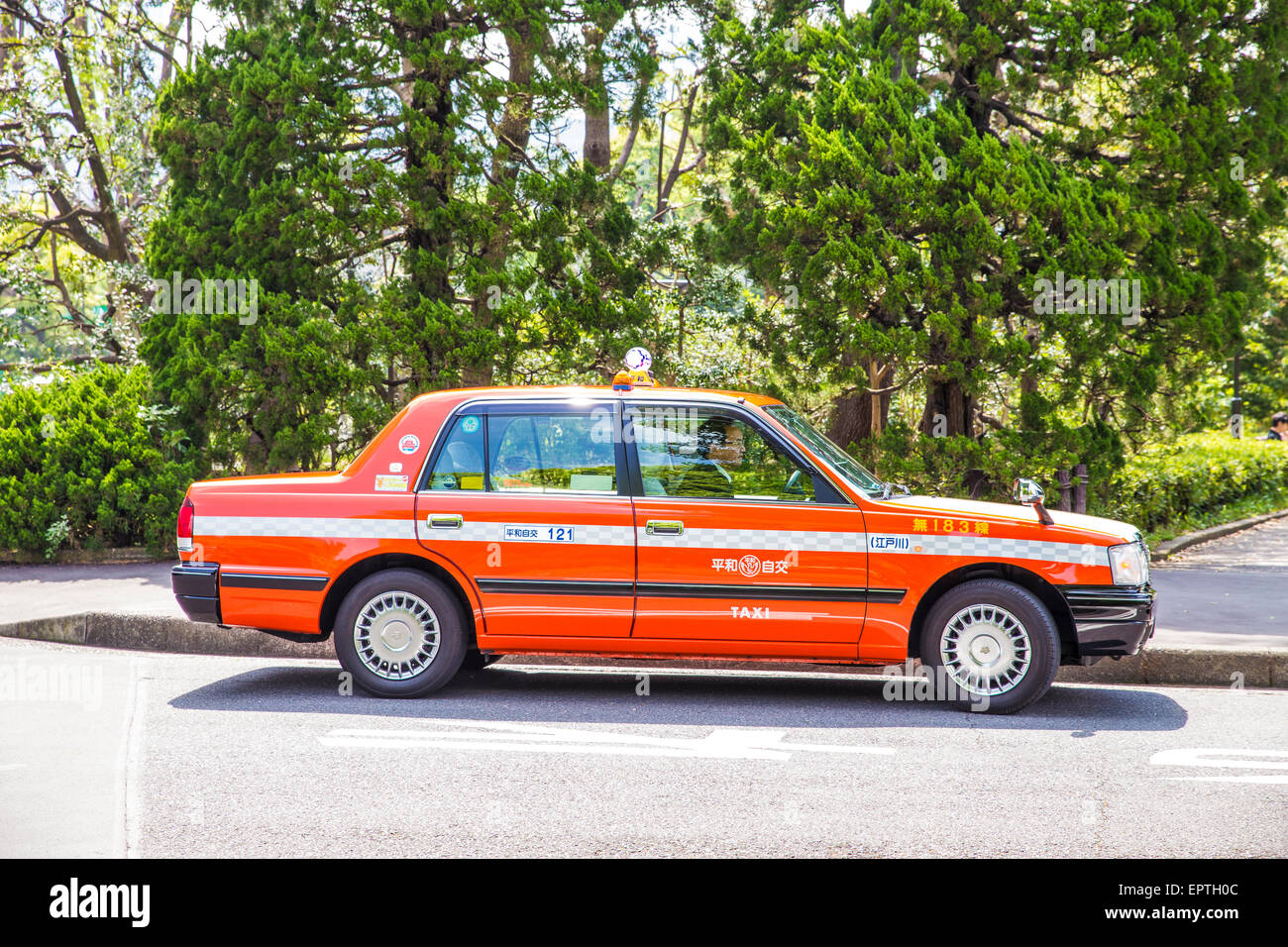 Orange taxi in street in Tokyo Japan Stock Photo - Alamy