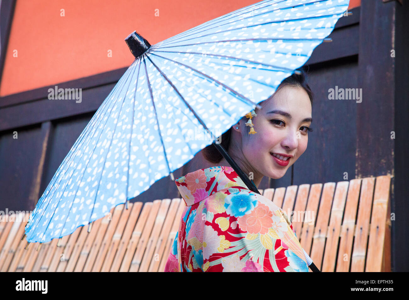 girl dressed as a geisha holding a parasol in Japan Stock Photo - Alamy