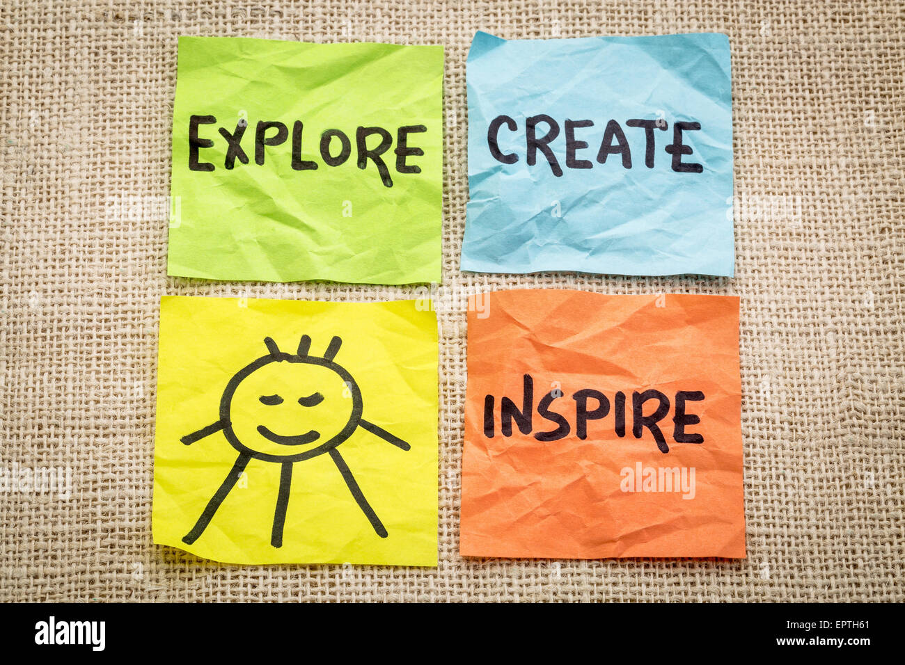 explore, create, inspire and smile reminder on sticky notes against ...