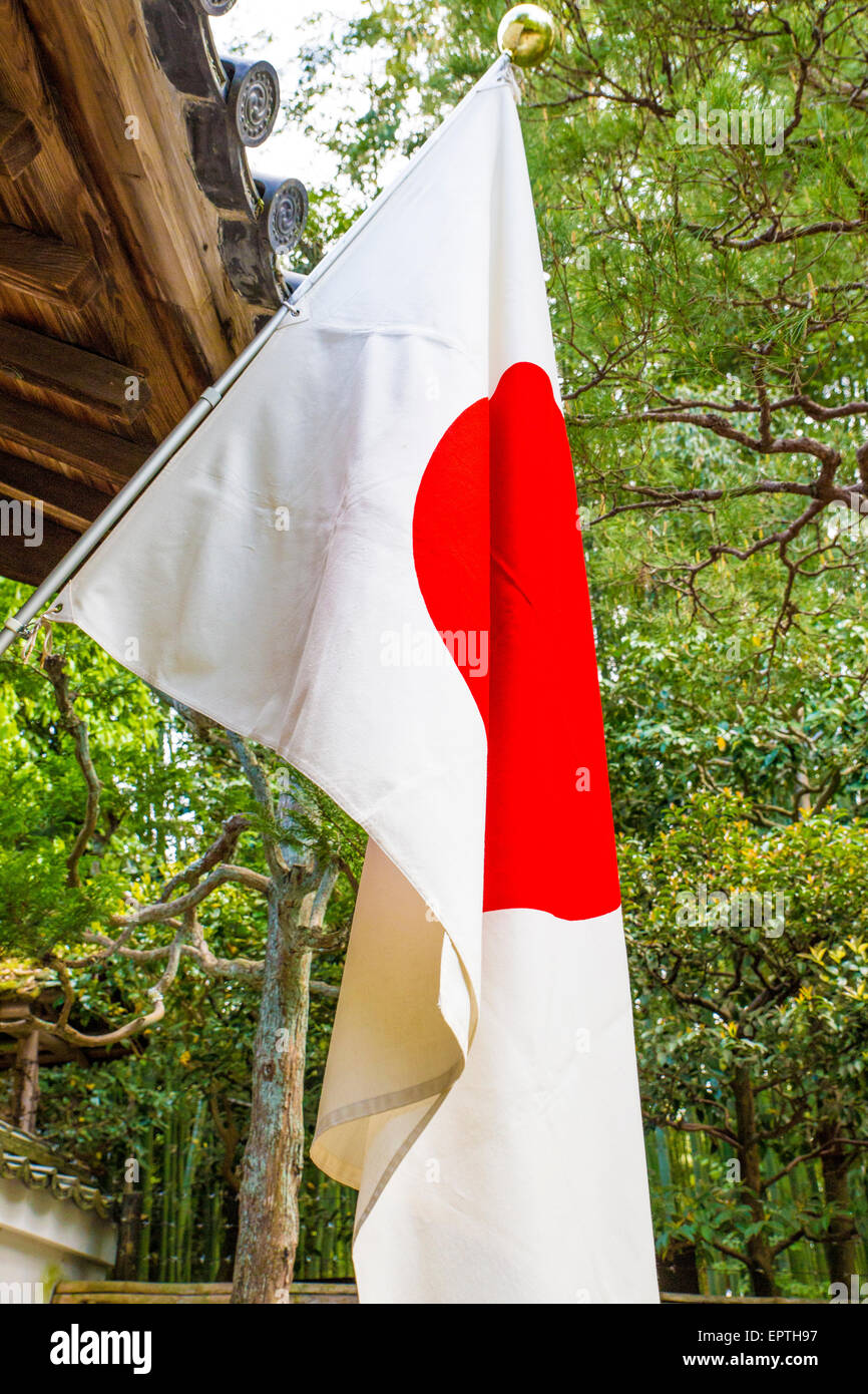 Japanese flag hanging against trees Stock Photo - Alamy