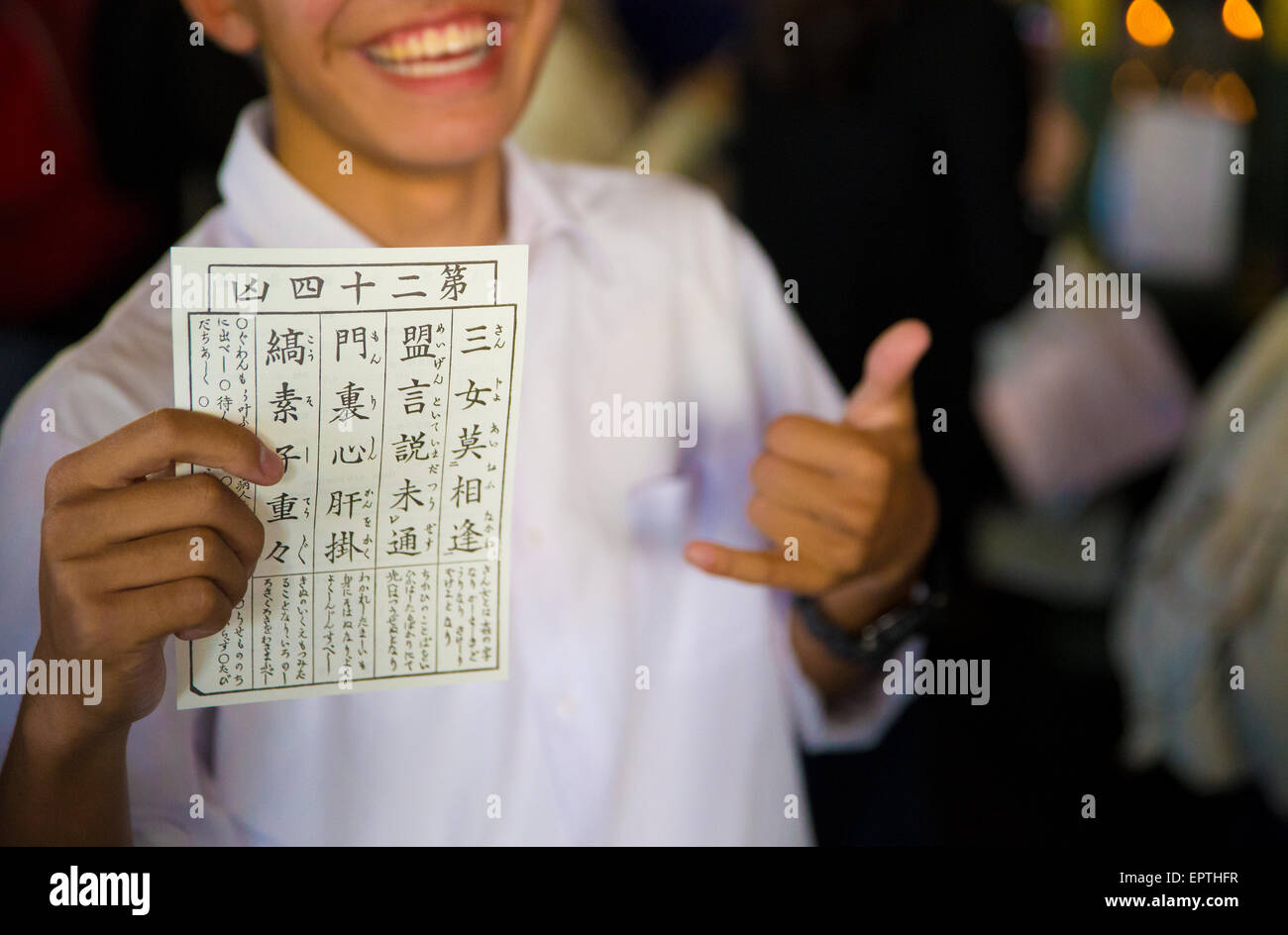 Boy holding out his fortune telling paper Stock Photo - Alamy