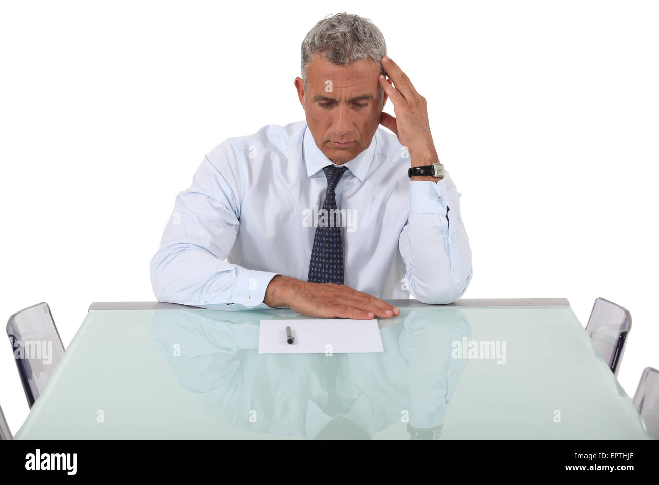 Concentrated man reading a document Stock Photo - Alamy
